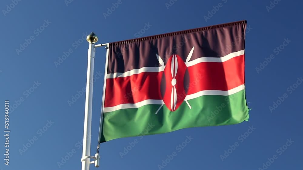 Close-up view of flag of Kenya waving in the wind on a blue sky ...