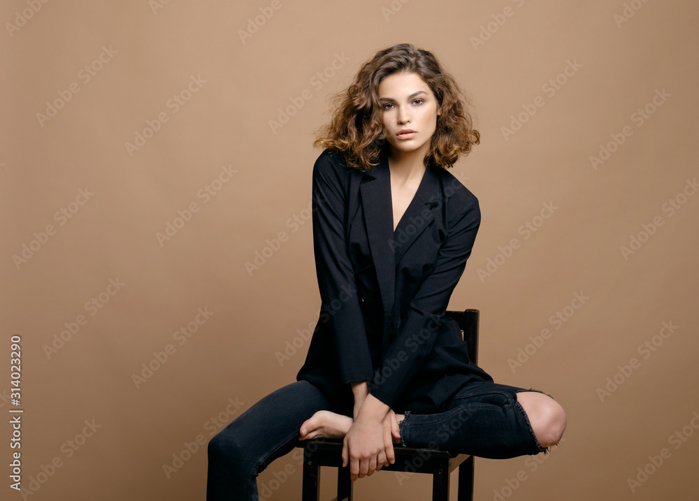 beauty fashion model with clean skin and curly hair in black jacket on ...