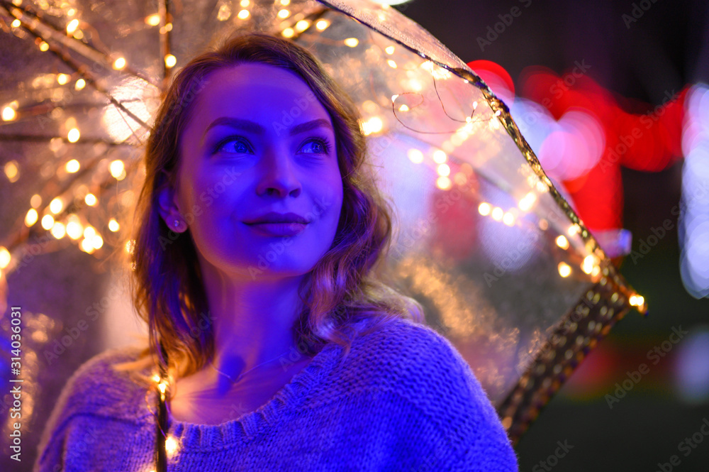 Girl at midnight in the rain with an umbrella and lights. Color and ...