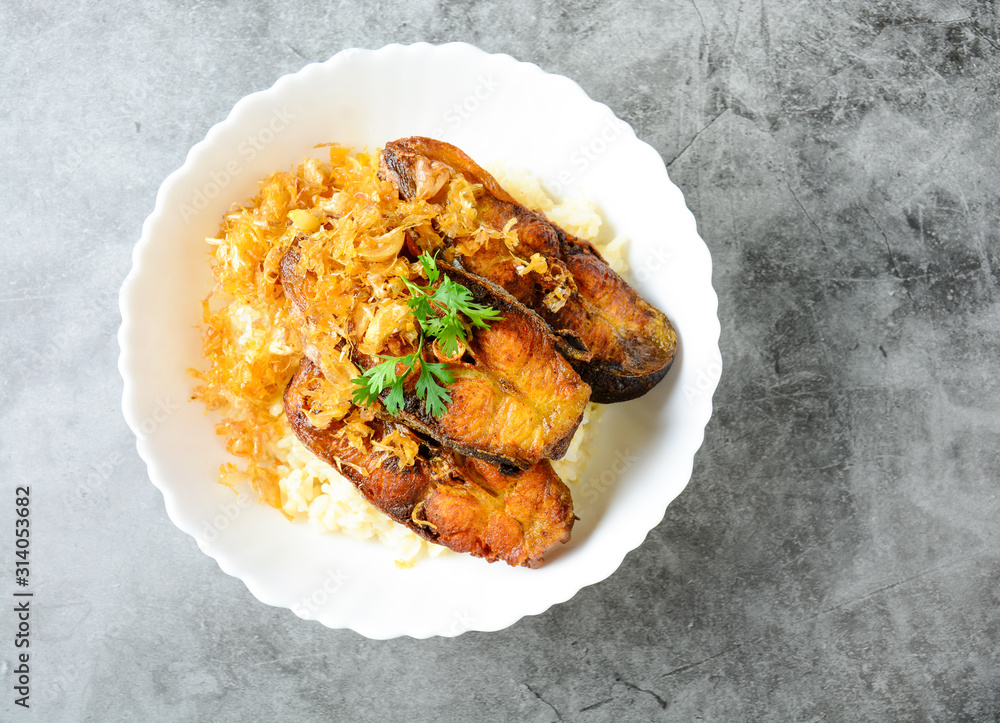 Deep fried sliced Pangasius fish with garlic, served with brown rice ...