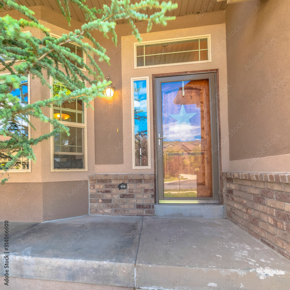 Square Home with bay window and glass paned door with sidelight and ...