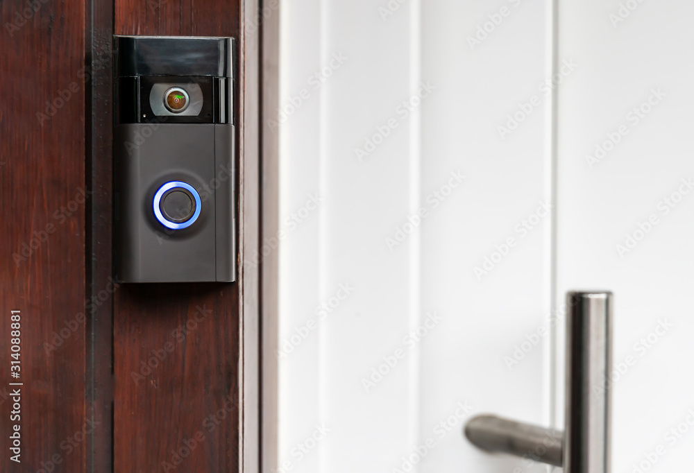 Foto de A modern surveillance camera is installed on a front door.A ...