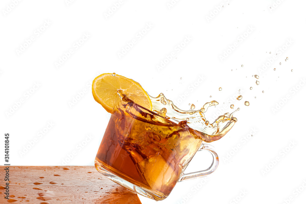 falling mug with tea or coffee on the corner of the table, splash and ...