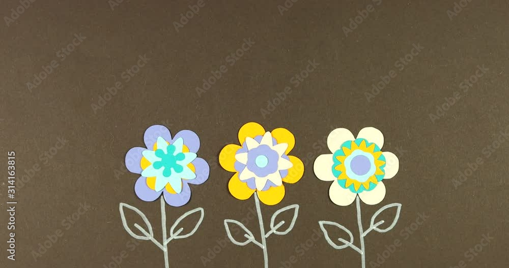 Animated stop motion background frame of blooming paper flowers on a ...