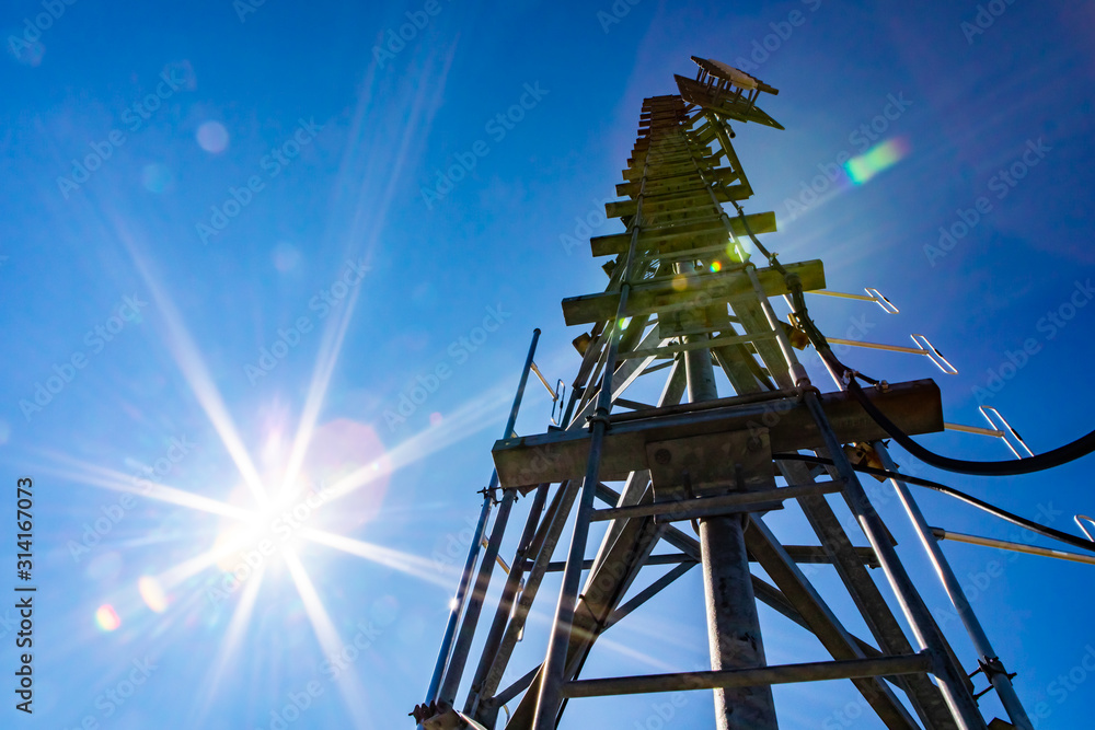 A low angle view of a radio transmission tower with multiple antenna ...