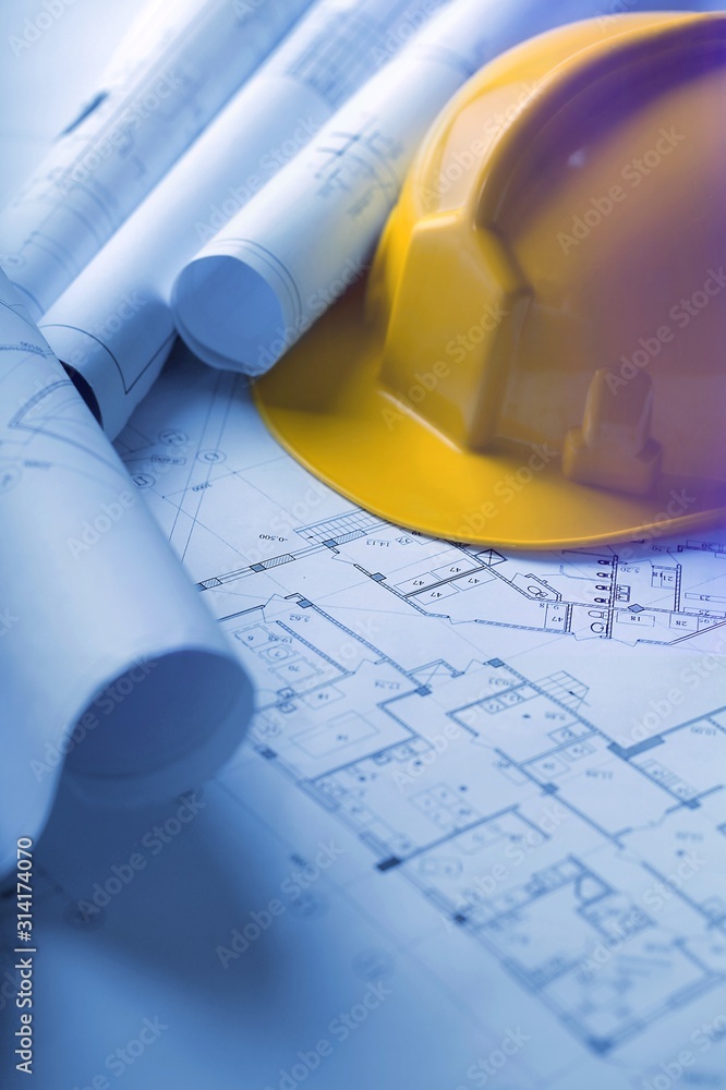 Paper blueprints construction and a yellow hardhat Stock Photo | Adobe ...