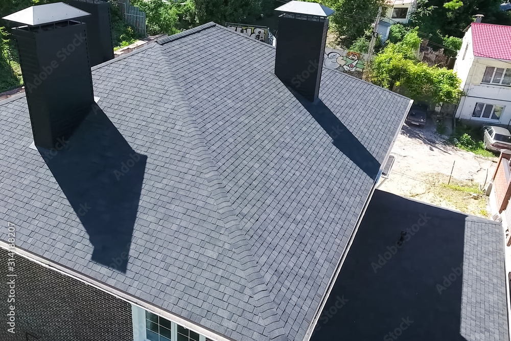 Bituminous tile for a roof. House with a roof from a bituminous Stock ...