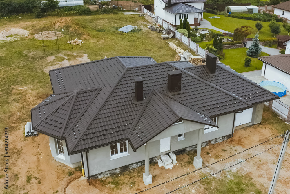 House with a brown metal roof.Corrugated metal roof and metal ro Stock ...