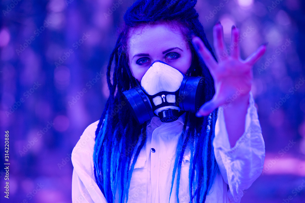 Neon. Biohazard. Woman in a hazmat suit wearing a respirator with ...
