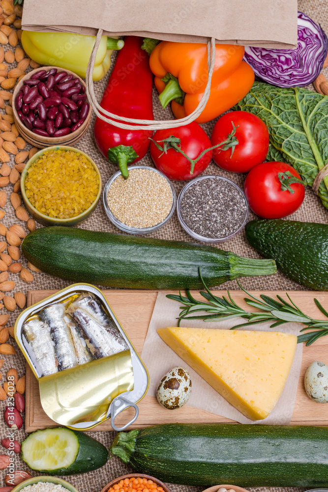 Set of healthy food: cheese sardines, leavy vegetables, beans nuts ...