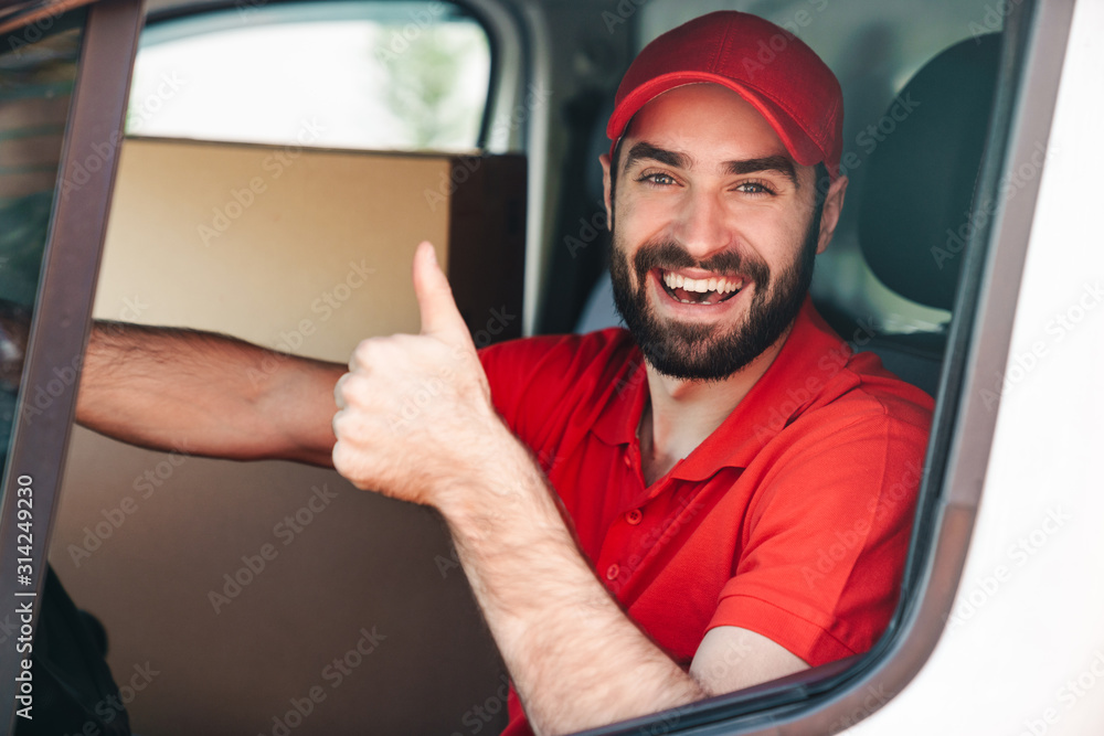 Image of happy delivery man showing thumb up and driving van Stock ...