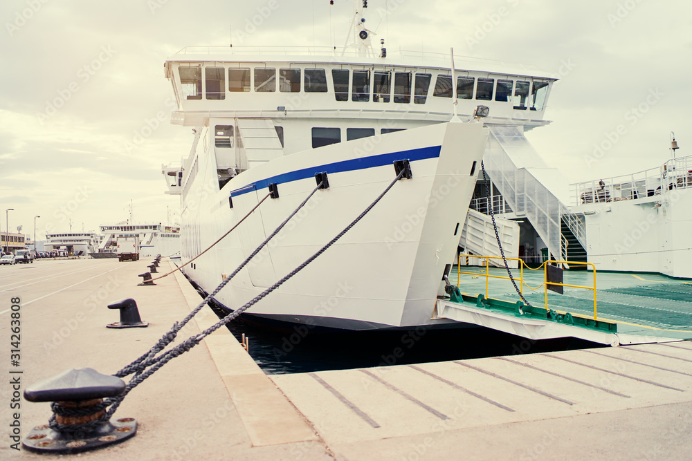 Ferryboat loading or unloading by a port pier. Concept of ...