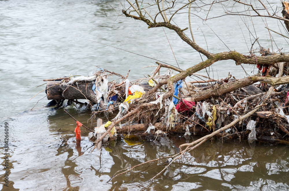 Plastic bags, bottles, garbage and trash dumped in the river in nature ...