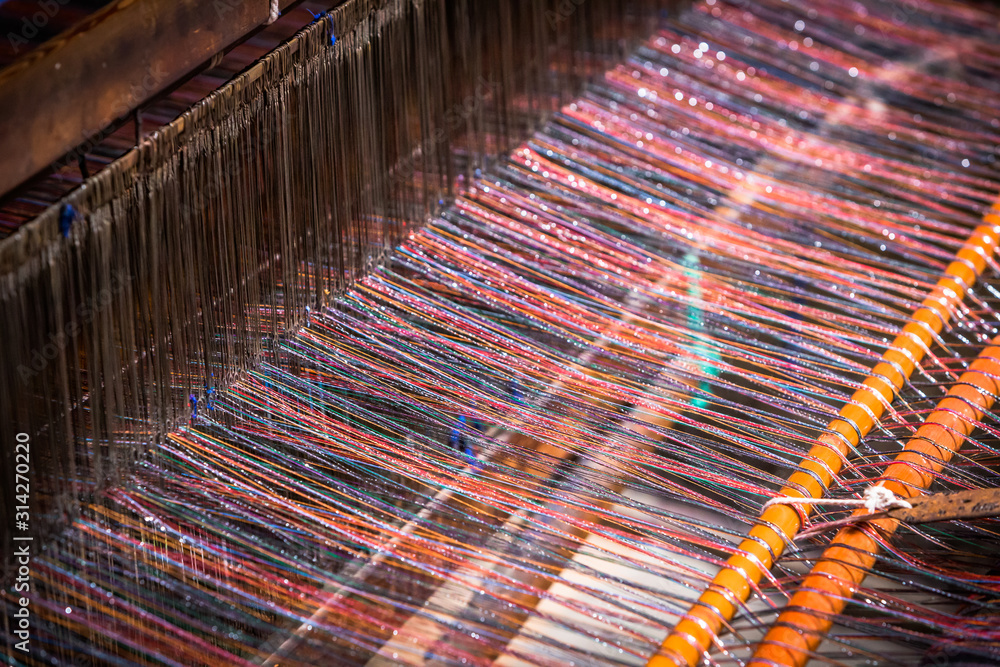 Old carpet weaver operating in a traditional way in the Medina of Fes ...