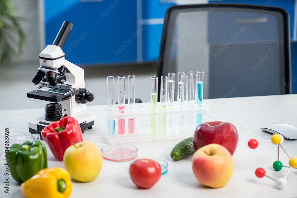 microscope, fruit, vegetables, test tubes on table in lab Stock Photo ...