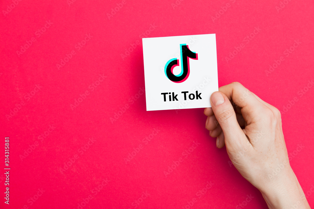 LONDON, UK - January 9th 2019: Hand holding Tik Tok logo. Tik Tok is a ...