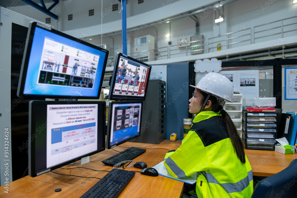 Inside the large Industry Factory Female Computer Engineer Works on ...