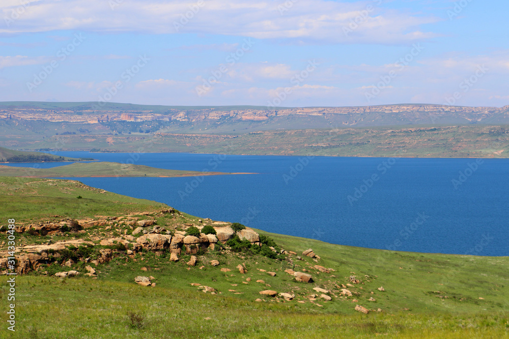 Sterkfontein Dam looking blue and full with green grass on a summers ...