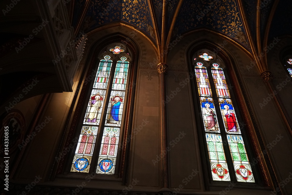 Stained glass windows of a private chapel in a a medieval castle. Two ...