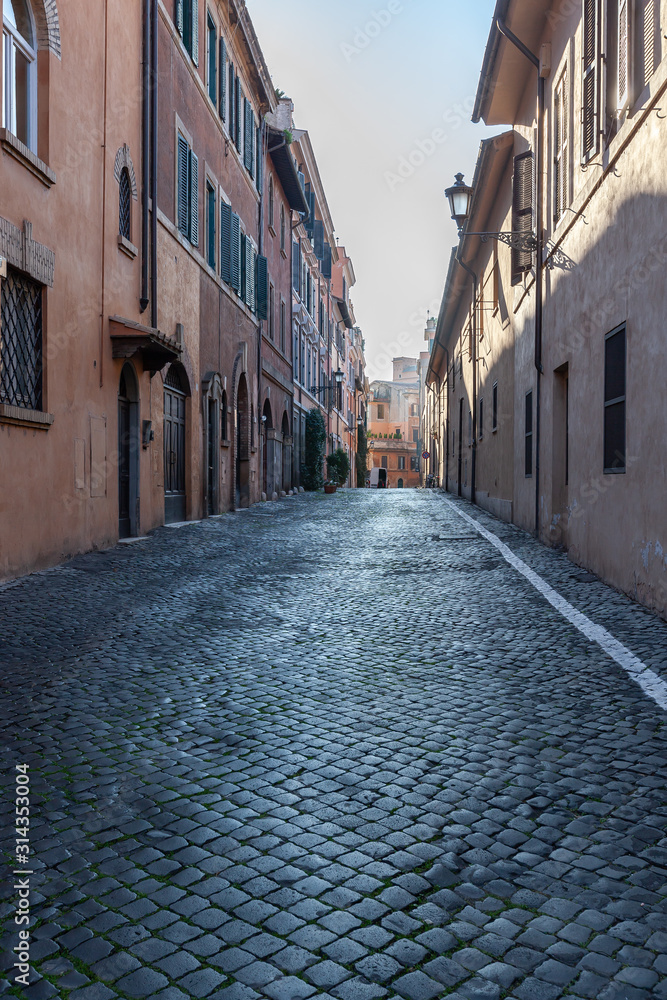 Old paved street with facades of ancient buildings in the town Rome ...