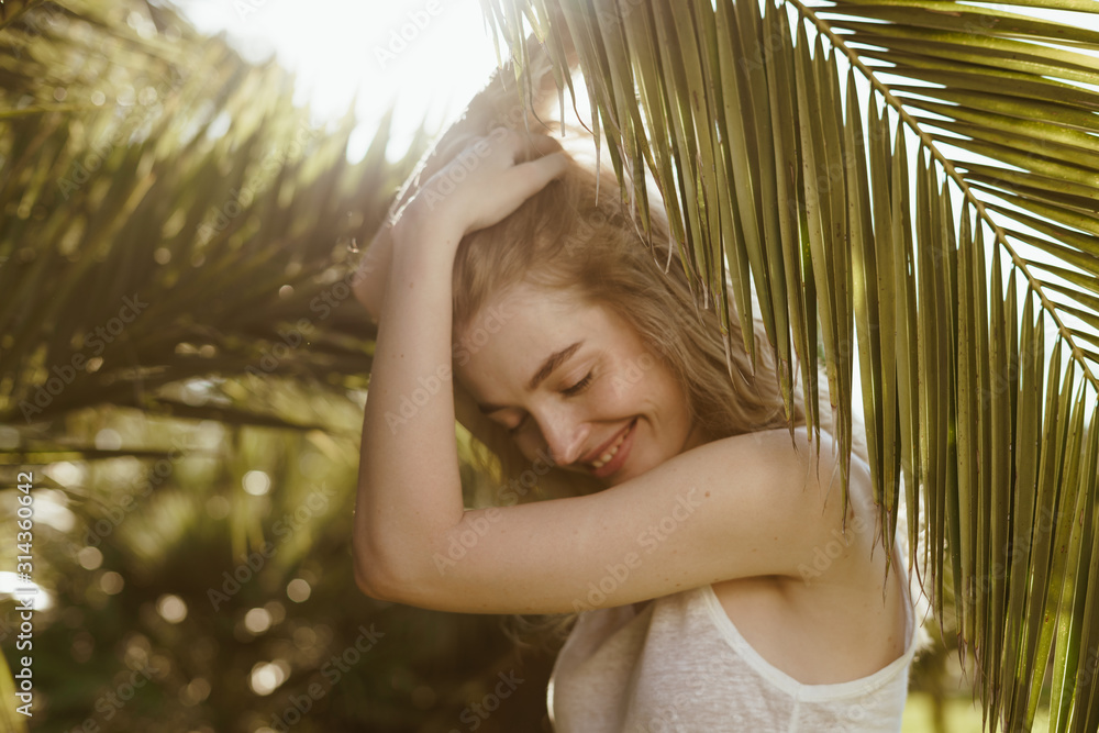 condescending smiling girl lowered her face down, covering her eyes and ...