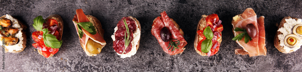 Appetizers table with italian antipasti snacks and wine in glasses ...