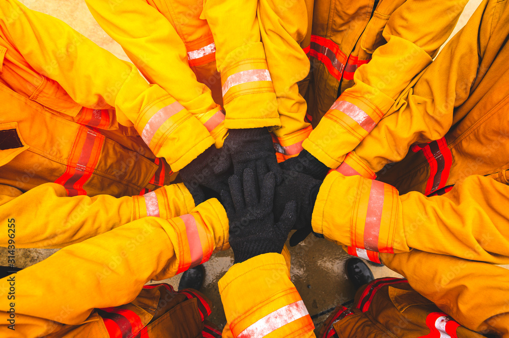 Firefighter putting hands up for fire fighting, Cheerful people giving ...