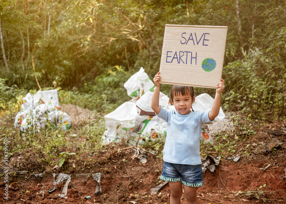 The little child girl holding "Save The Earth" Poster showing a sign ...