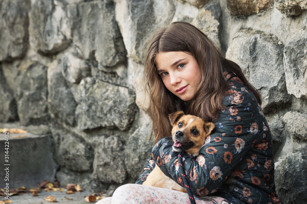 cute teen girl hugging her new pet adopted friend dog from rescue ...