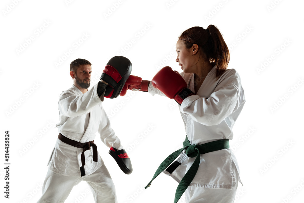 Junior in kimono practicing hand-to-hand combat with coach, martial ...