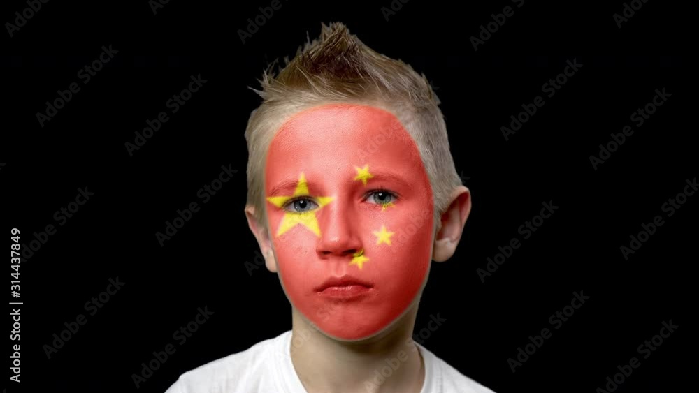 Sad fan of the football team of China. A child with a face painted in ...