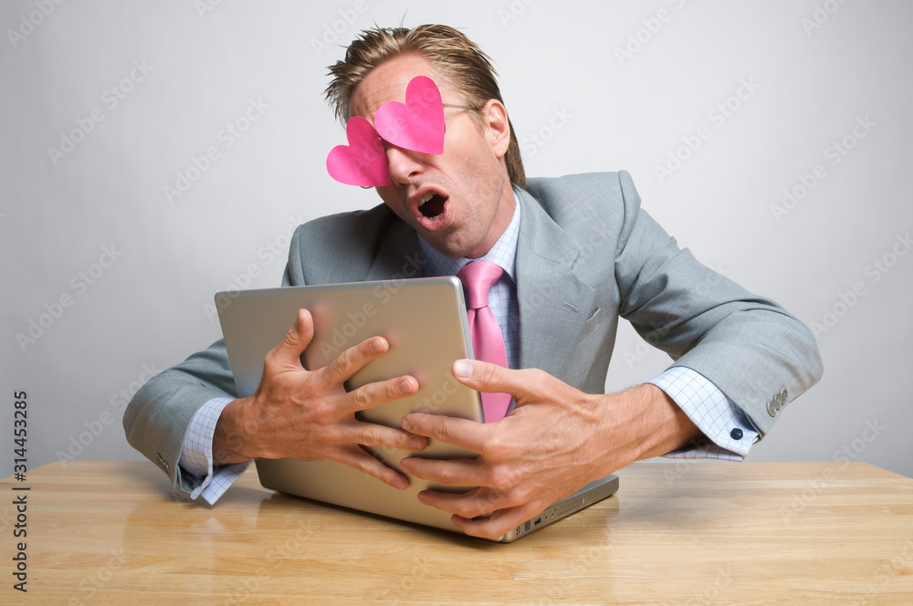 Office worker blinded by pink hearts talking to the screen while ...