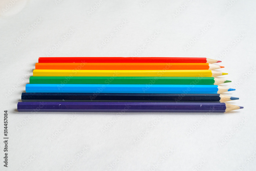 Set of rainbow colored pencils on blank sheet of white paper, seen in ...