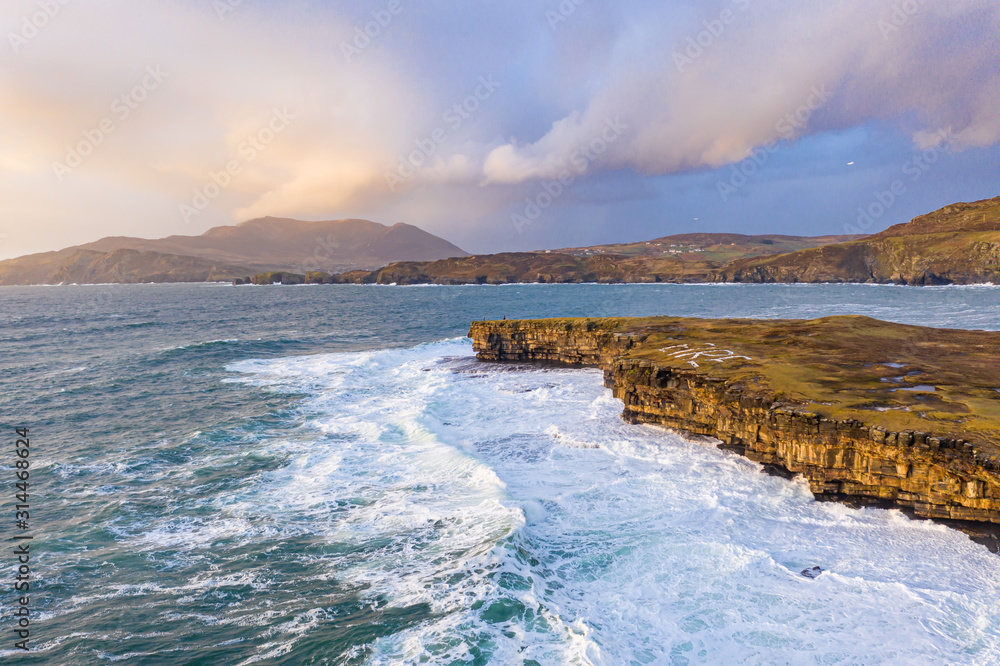 Aerial view of huge waves breaking at Muckross Head - A small peninsula ...