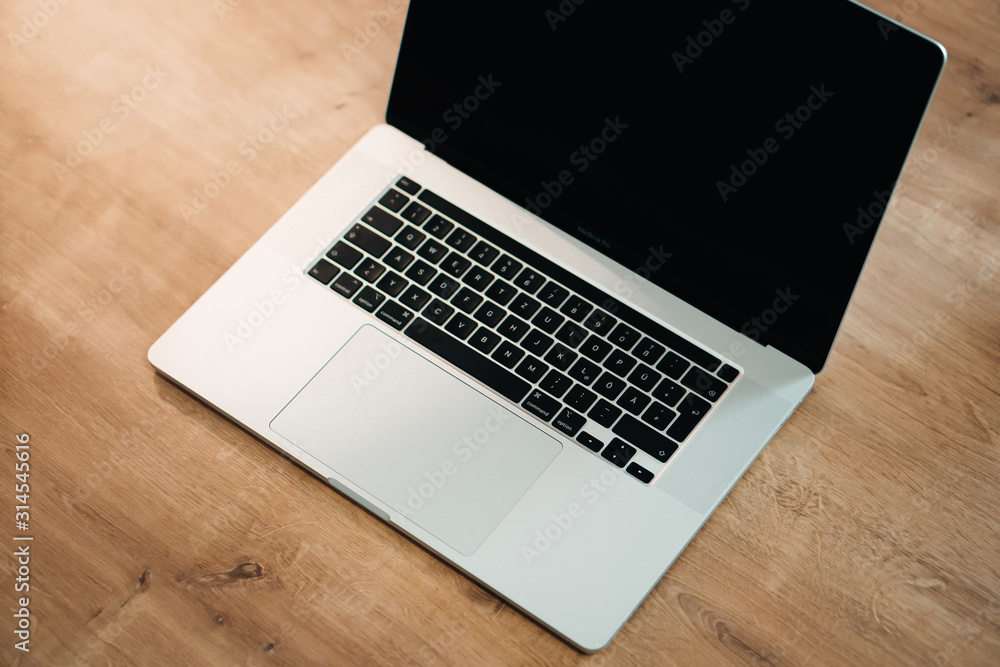 New Apple Macbook Pro on the wooden close up background. Stock Photo ...