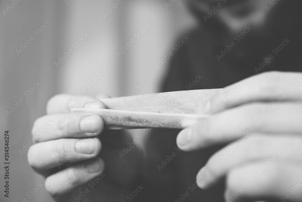 Preparing a joint and drug paraphernalia concept theme with close up ...