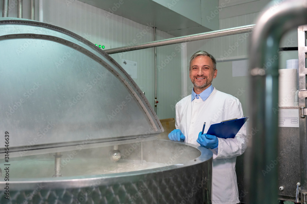 Smiling Dairy Plant Food Engineer Standing Beside Stainless Steel Milk ...