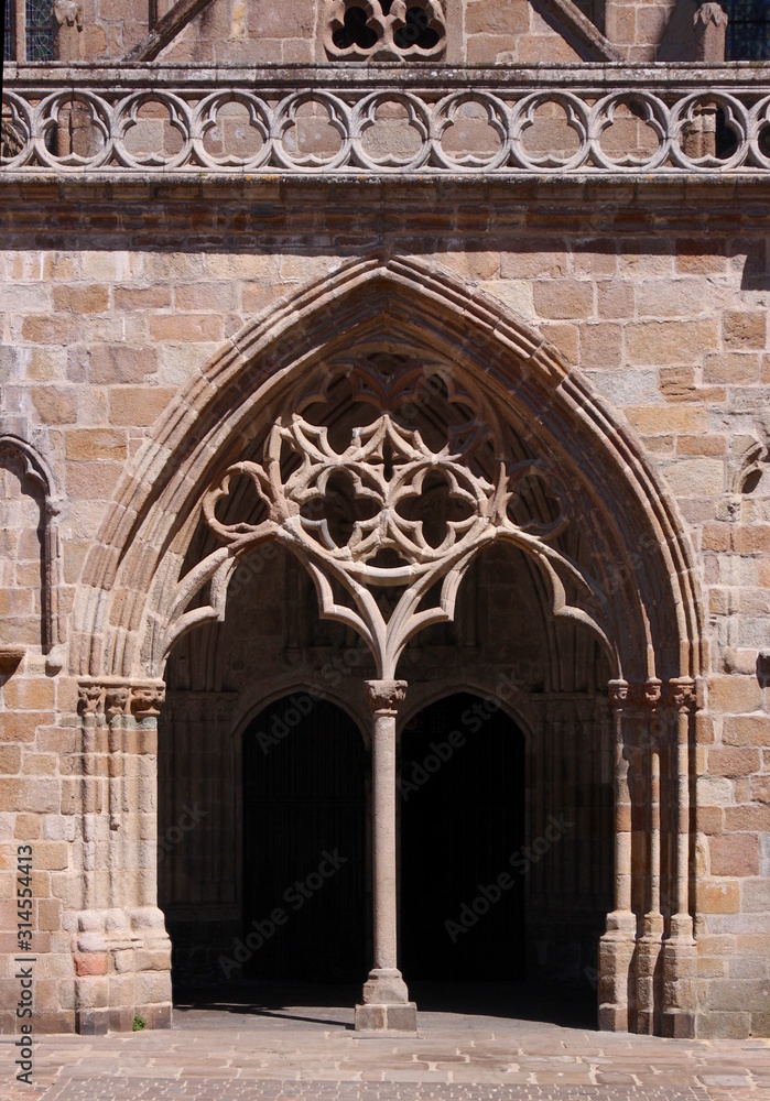 Entrance with gothic tracery and wooden door at the cathedral of ...