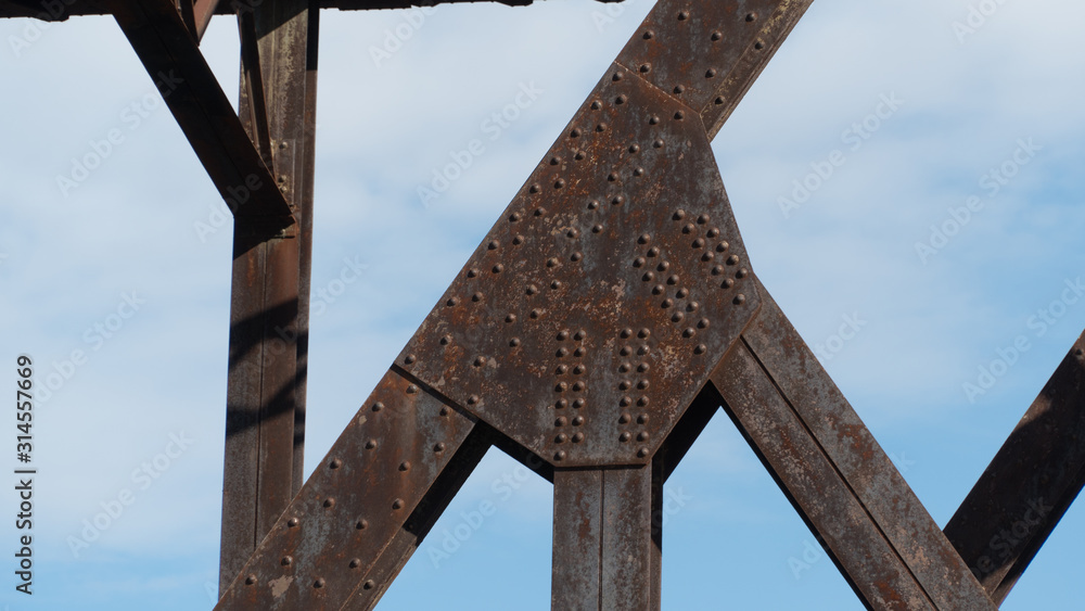 Details of a weathered steel truss bridge; bracing, joints and rivets ...