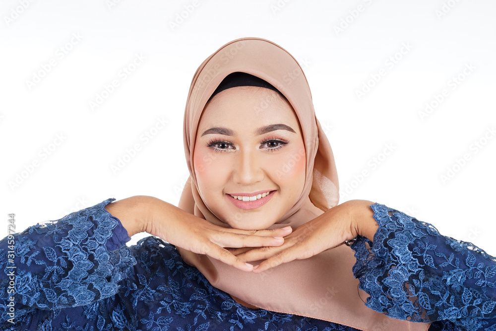A beautiful female Muslim model wearing dark blue modern kurung with ...
