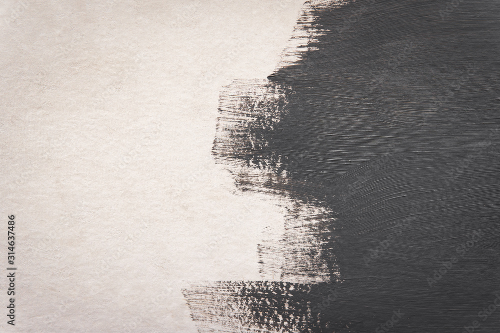 Grey paint unevenly brushed in an artistic pattern across a cream ...