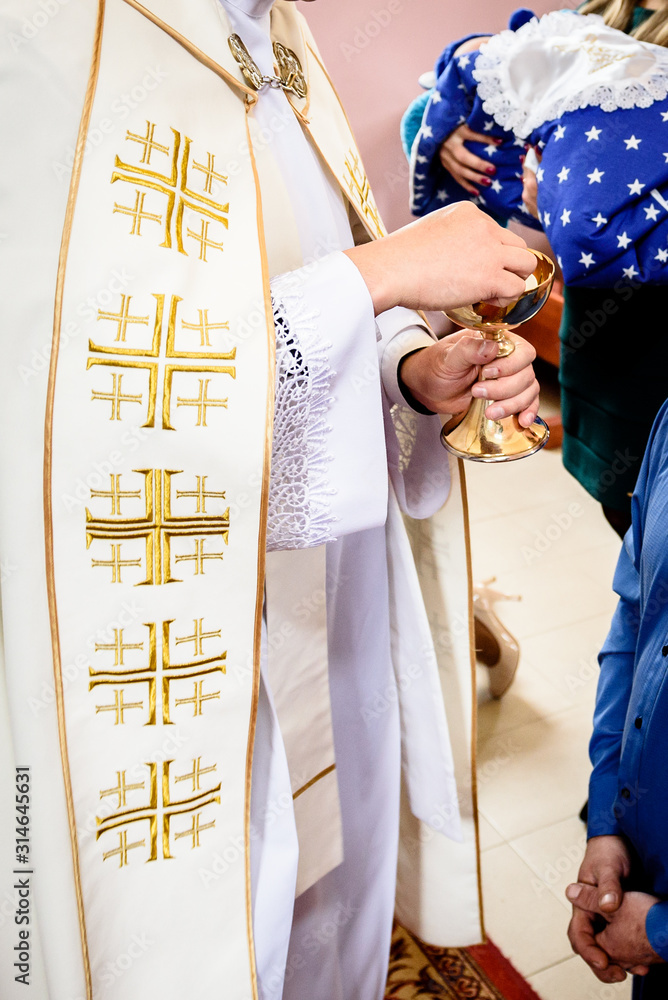 Catholic priest giving holy communion. Stock Photo | Adobe Stock