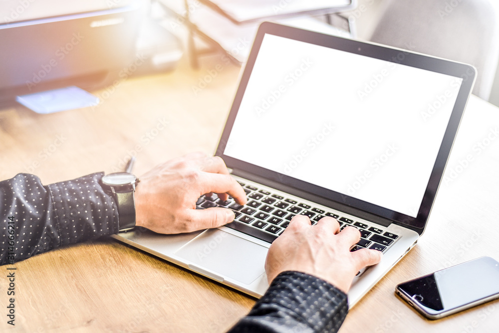 Laptop with blank screen on table, Man hands working on his computer in ...