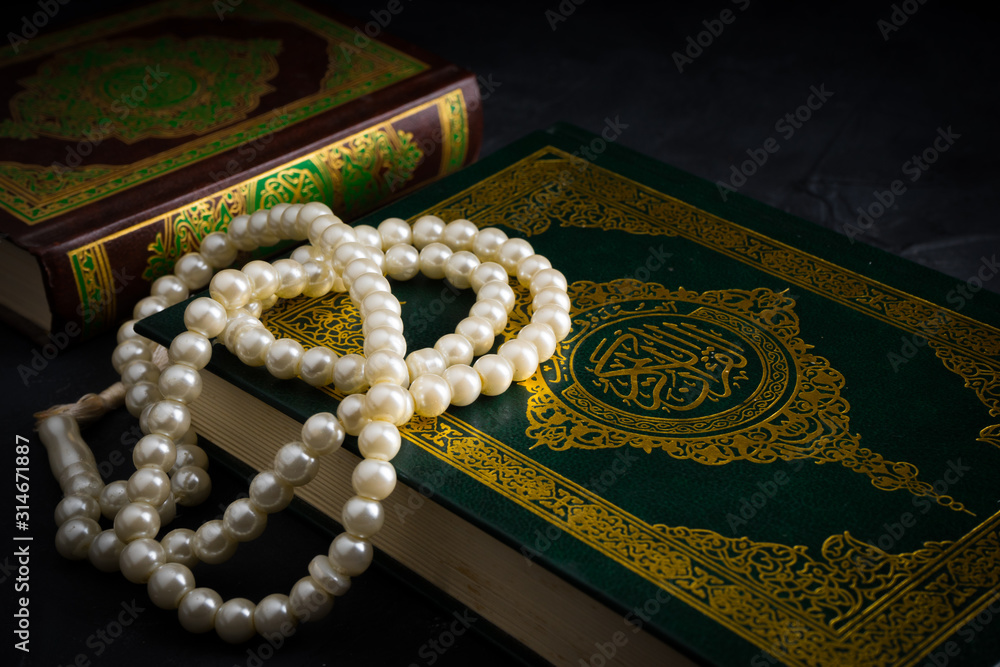 Faith in Islam concept. The Islamic holy book, Quran or Kuran, with ...