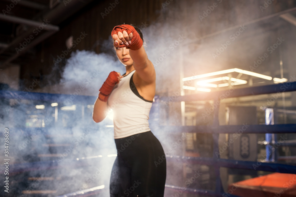 Professional caucasian female fighter in ring. Young beautiful fit ...