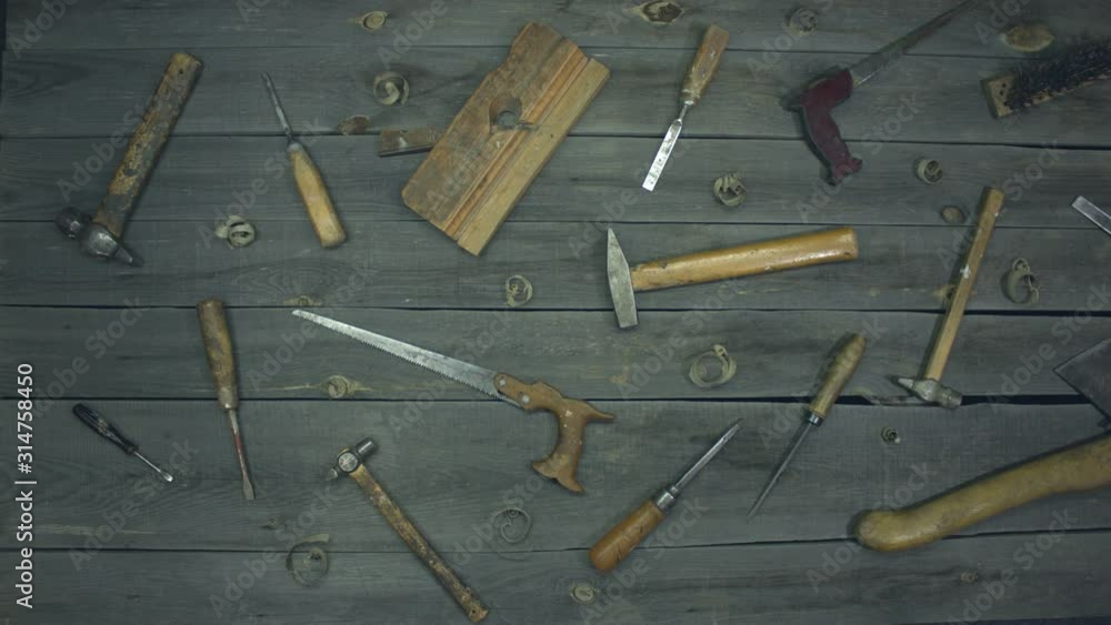 Old hand tools. Top view. On the table are mixed work tools ...