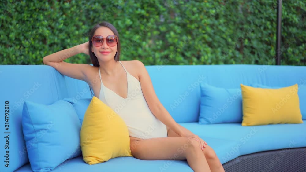 Young Asian Female Wearing White One Piece Swimsuit And Sunglasses
