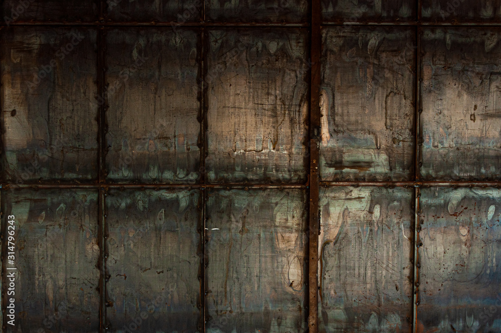 Background from a steel wall from sheets of iron welded together by ...