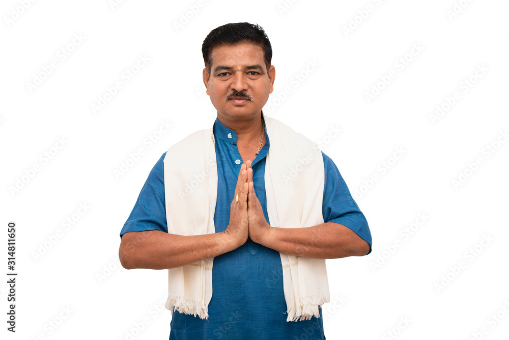 Handsome Indian man in traditional ware showing namaste gesture on ...