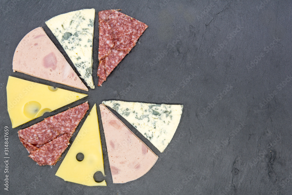 pizza topping cut as slices of pizza on black slate top view Stock ...